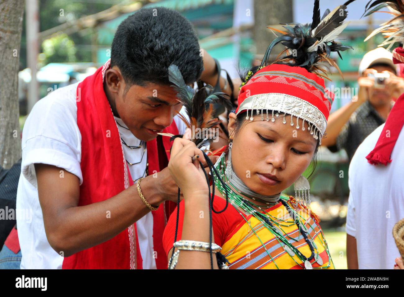 Women from the Garo community in traditional dress and ornaments, at a ...