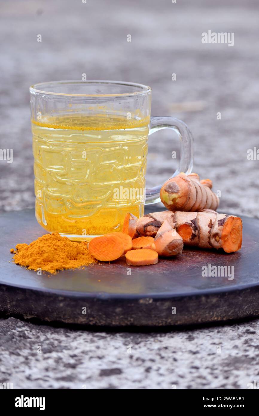 closeup the bunch sliced orange turmeric with juice and powder on the ...