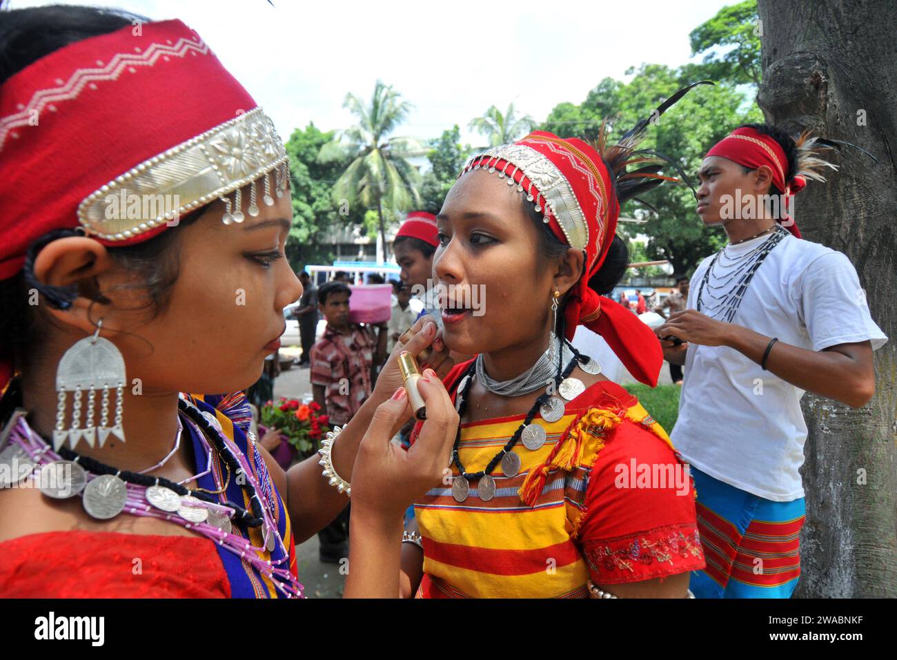 Women from the Garo community in traditional dress and ornaments, at a ...
