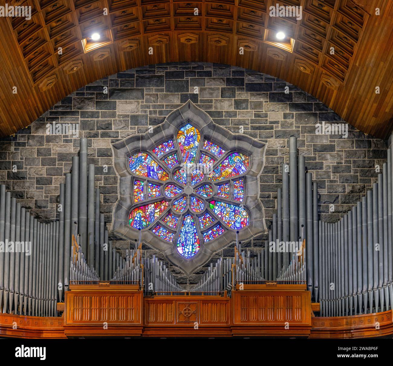 Interior view of the pipe organ and stained glass rose windows in ...
