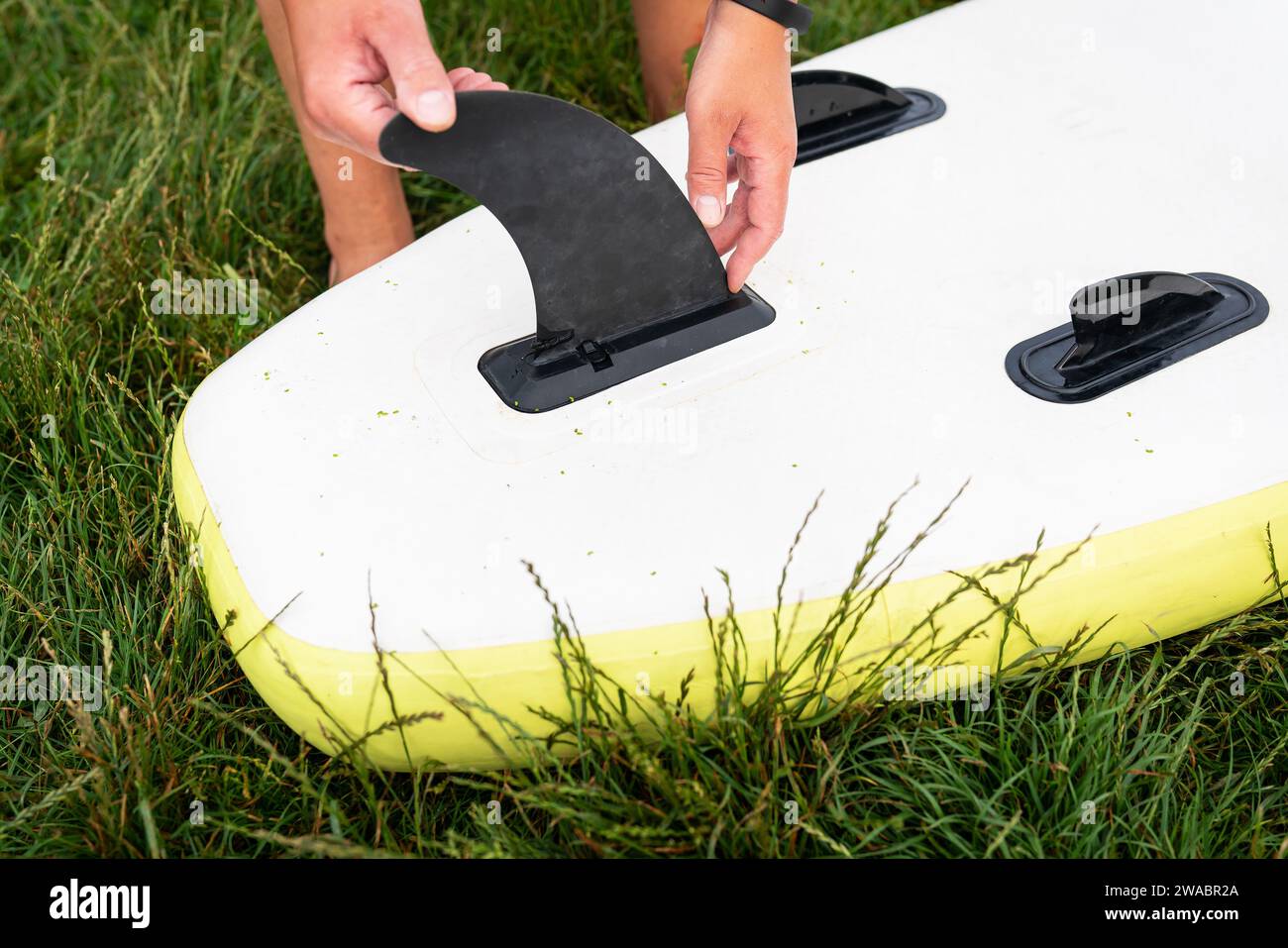The image shows a man attacking a black fin to the bottom of a white ...