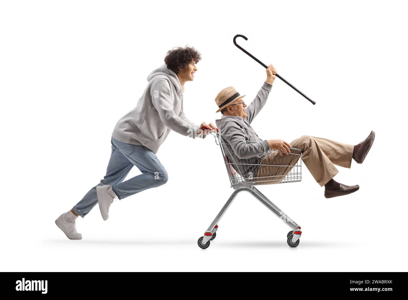 Guy running and pushing a senior man with a cane inside a shopping cart ...