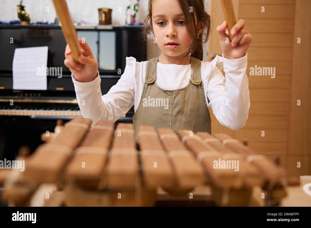 Adorable elementary age Caucasian little child girl playing wooden ...