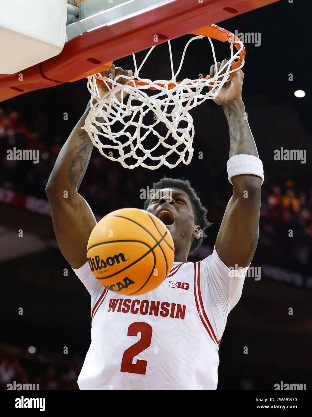Madison, WI, USA. 2nd Jan, 2024. Wisconsin Badgers guard AJ Storr (2) throws down an alley oop ...