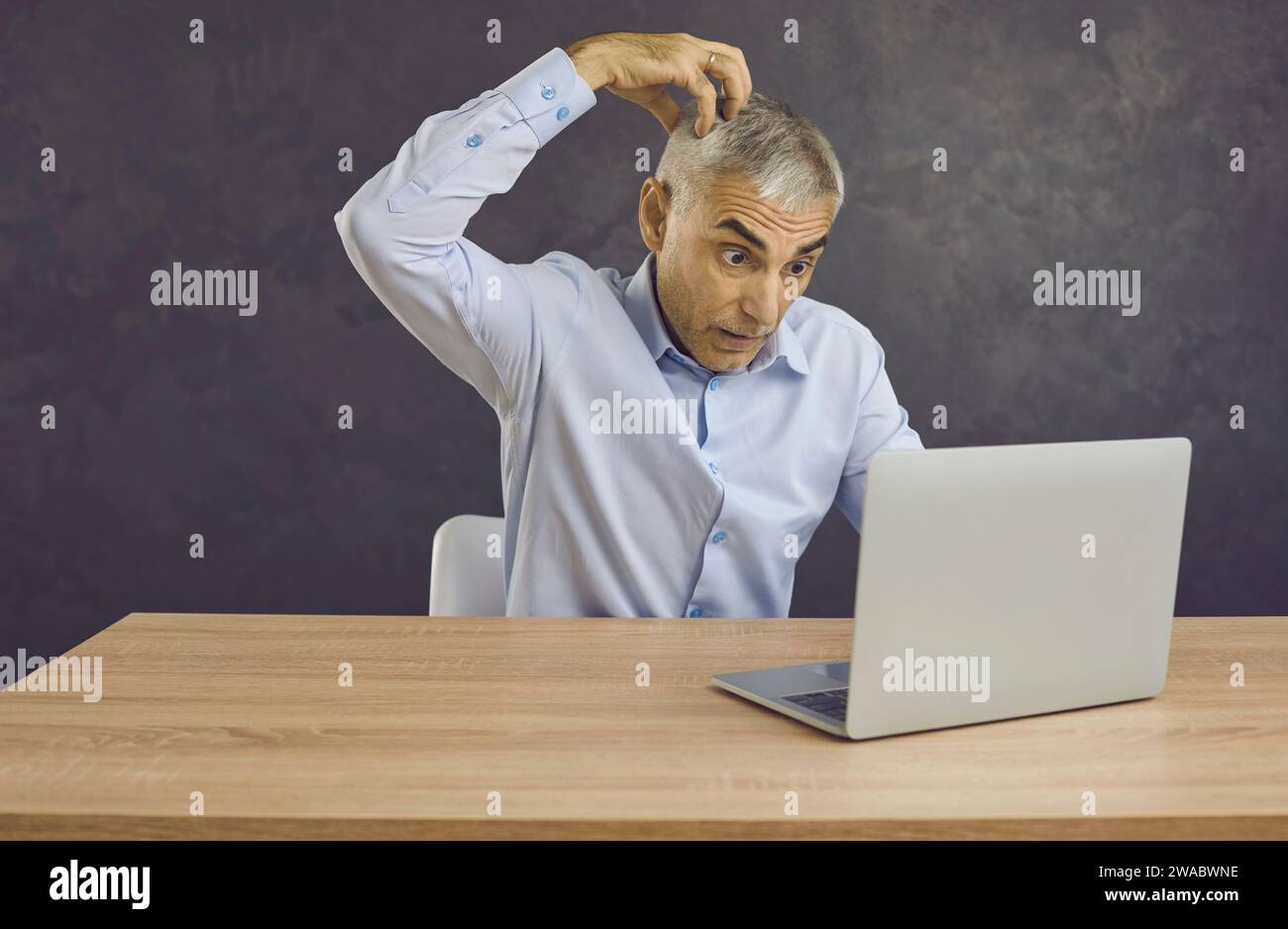 Confused man work on computer feel frustrated Stock Photo - Alamy
