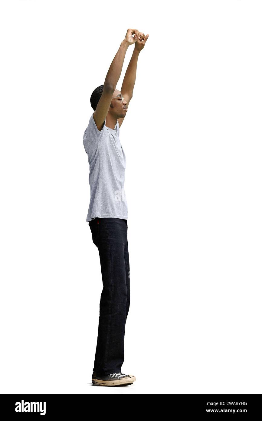 A man in a gray T-shirt, on a white background, in full height, raised ...