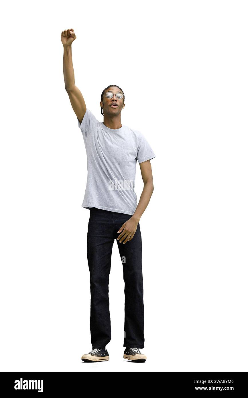 A man in a gray T-shirt, on a white background, in full height, raised ...