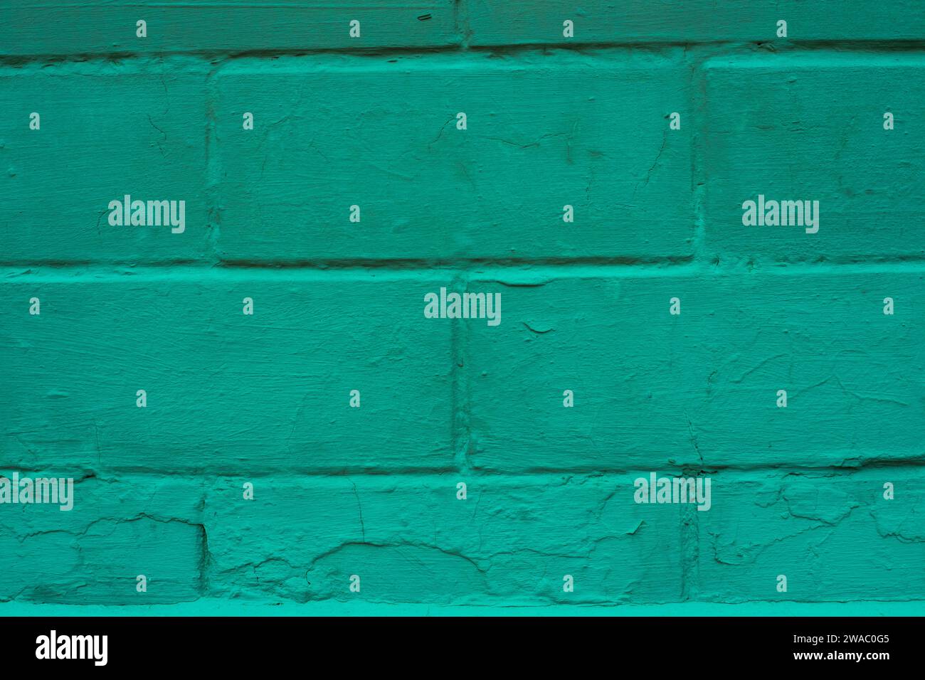Close-up wall of large bricks painted with green paint Stock Photo - Alamy