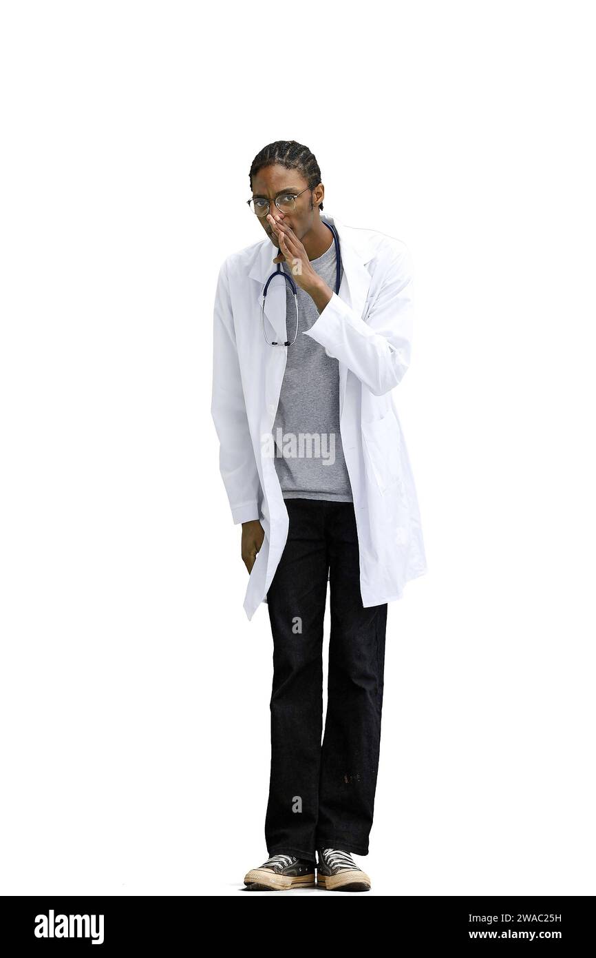 A male doctor, on a white background, in full height, tells a secret ...