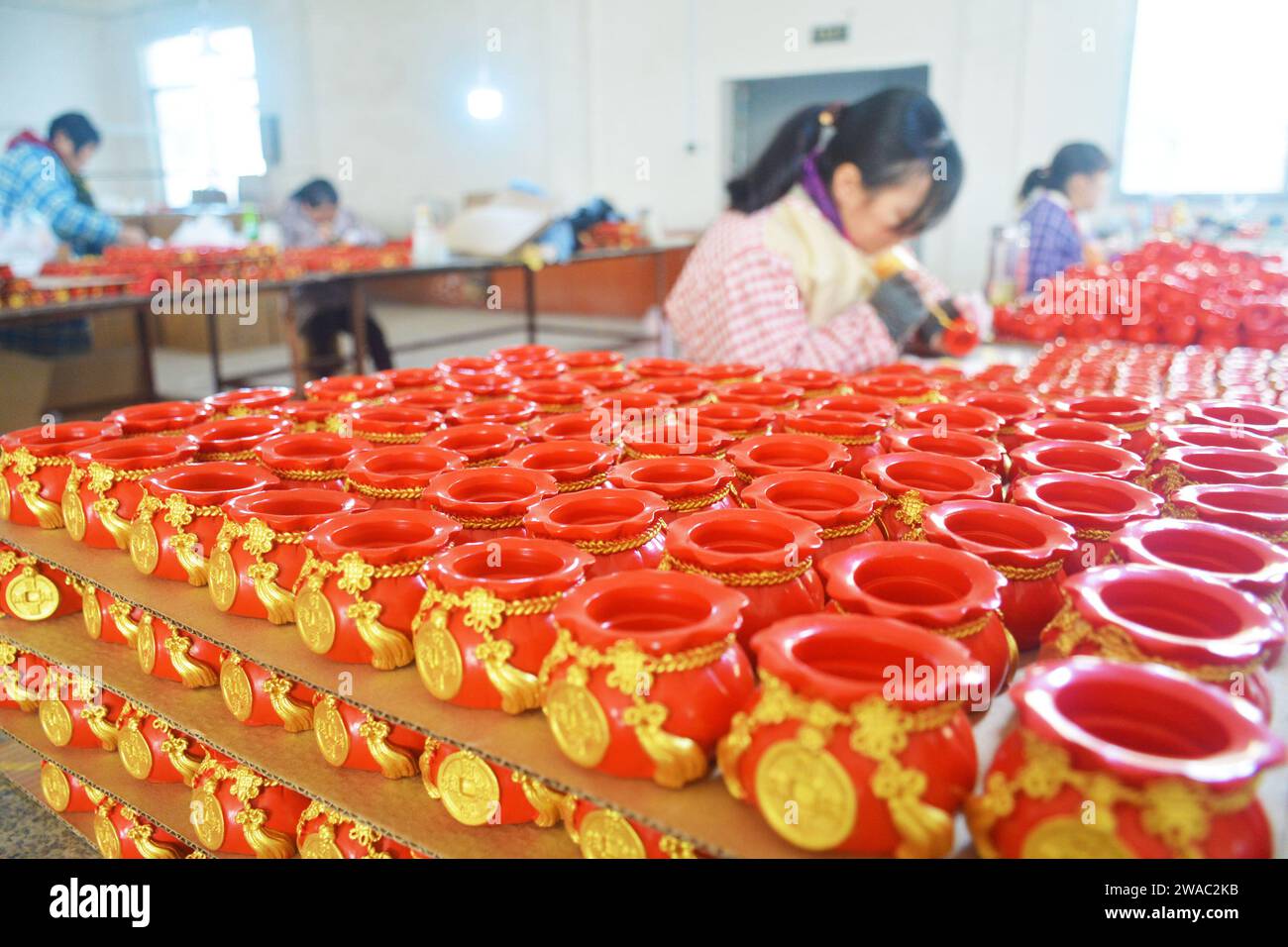 Anqing, China. 03rd Jan, 2024. A worker is painting handicrafts at a ...