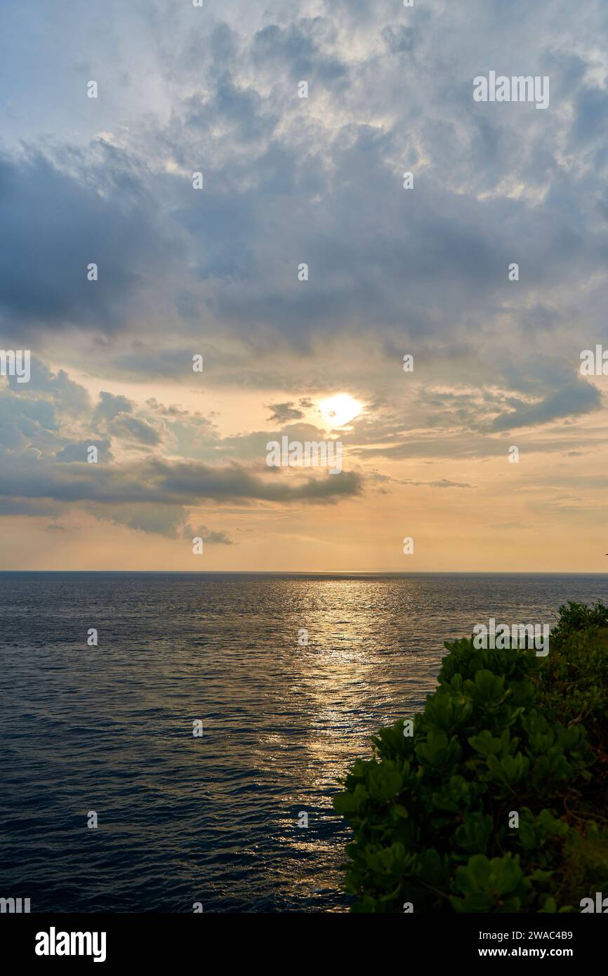 The view of the mountain and the ocean at sunset. A sunny path over the ...