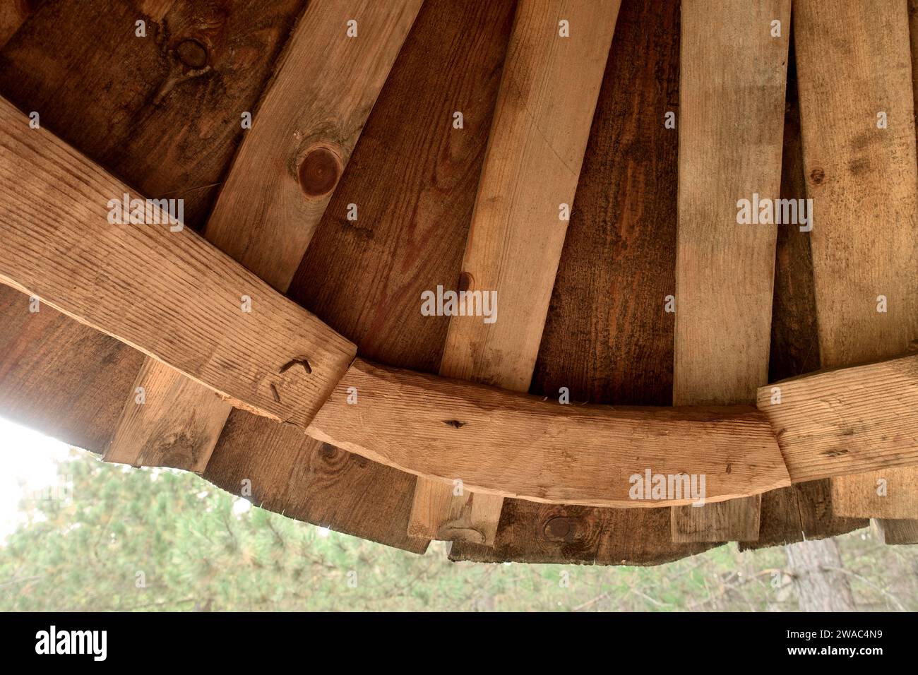 structural detail of the lower part of a rounded corner of a wooden ...