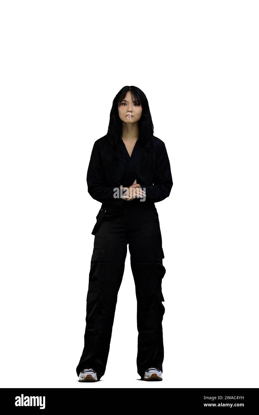 A woman in black clothes, on a white background, in full height ...