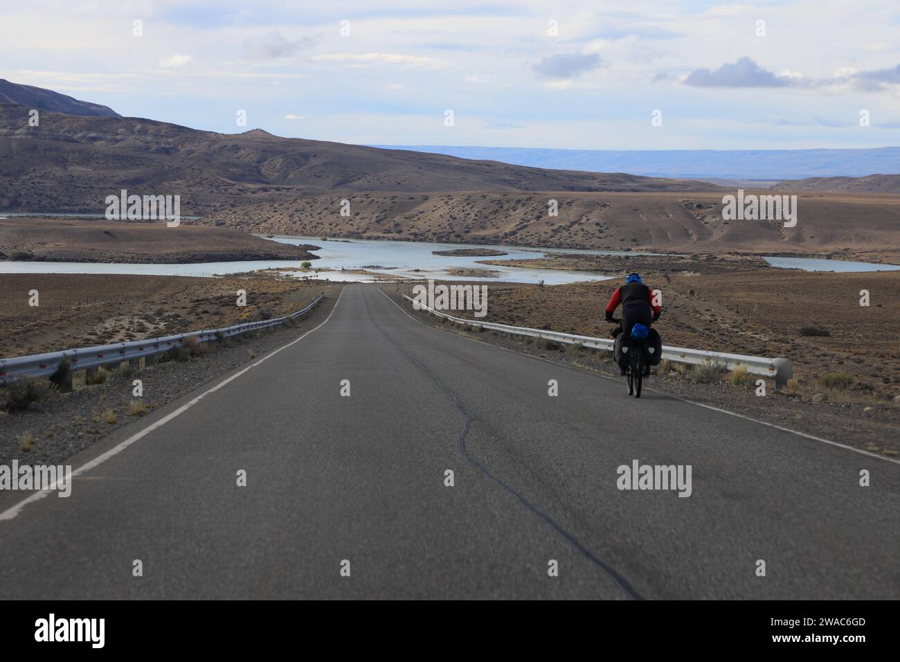 A cyclist riding bicycle on province route 23 towards El Chalten in ...
