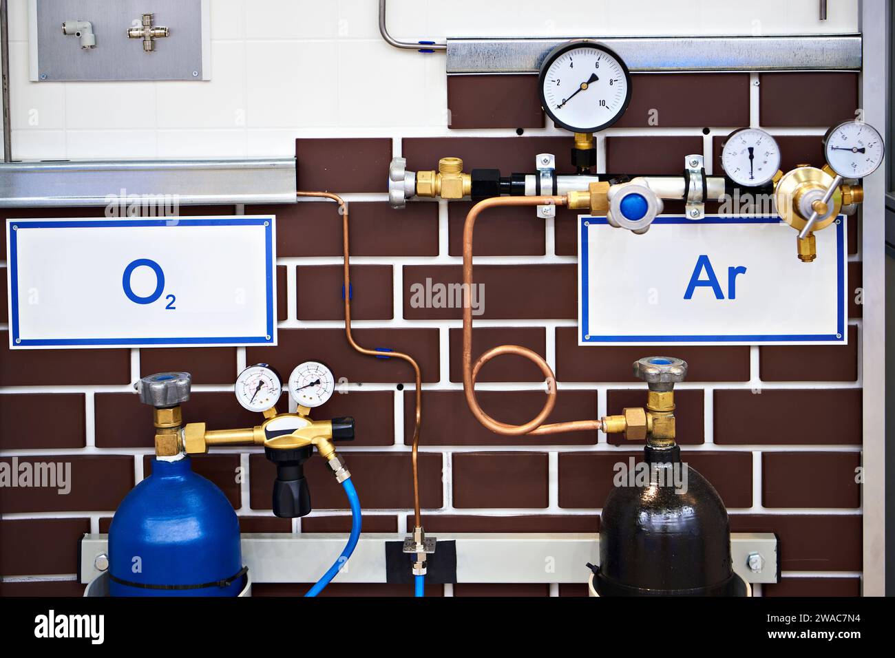 Oxygen and argon cylinders and piping with pressure gauges Stock Photo ...
