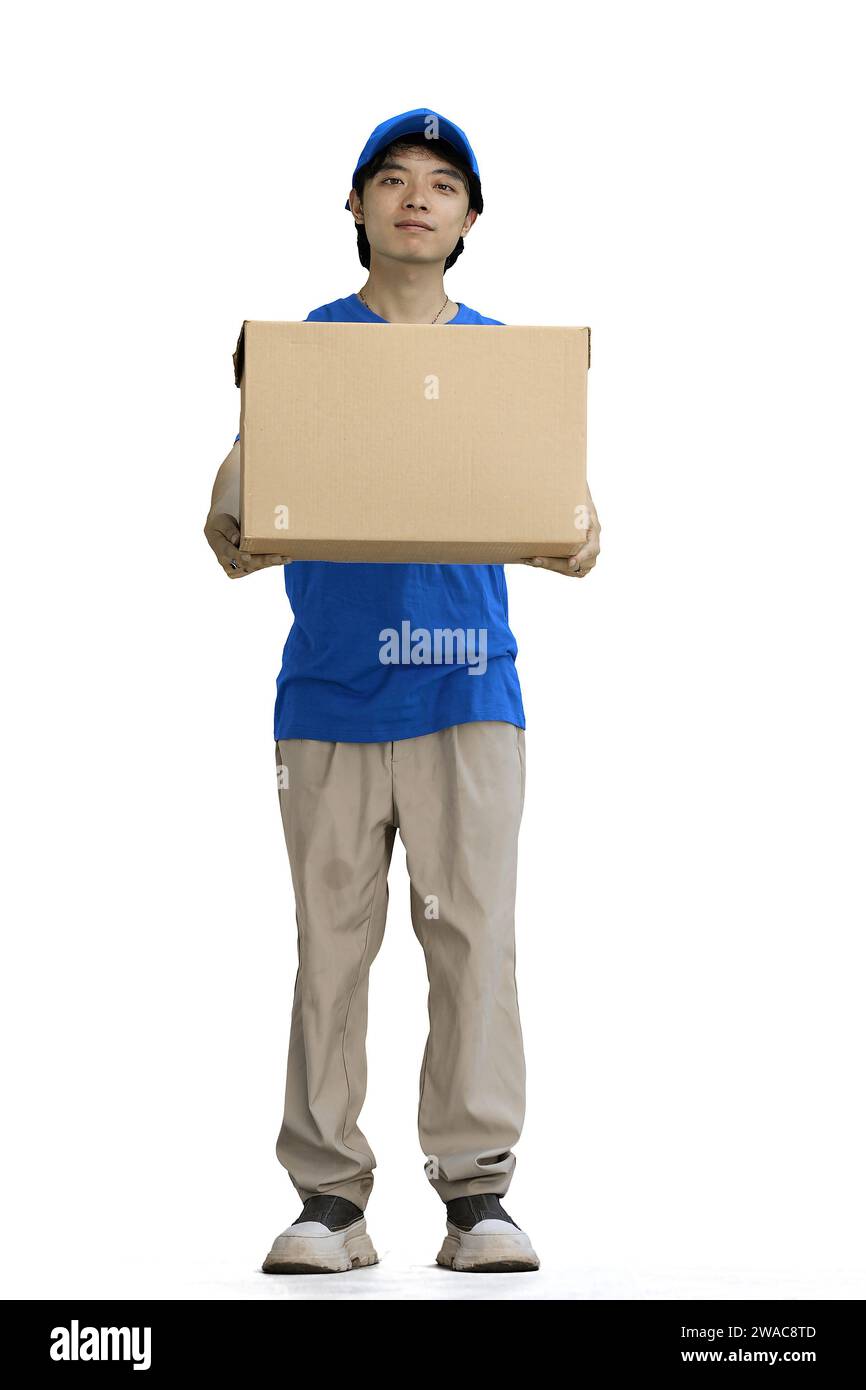 The delivery guy, on a white background, in full height, gives a box ...