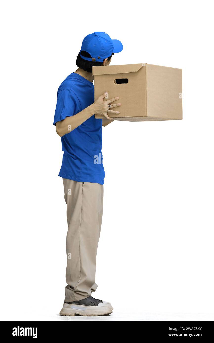 The delivery guy, on a white background, in full height, shakes the box ...