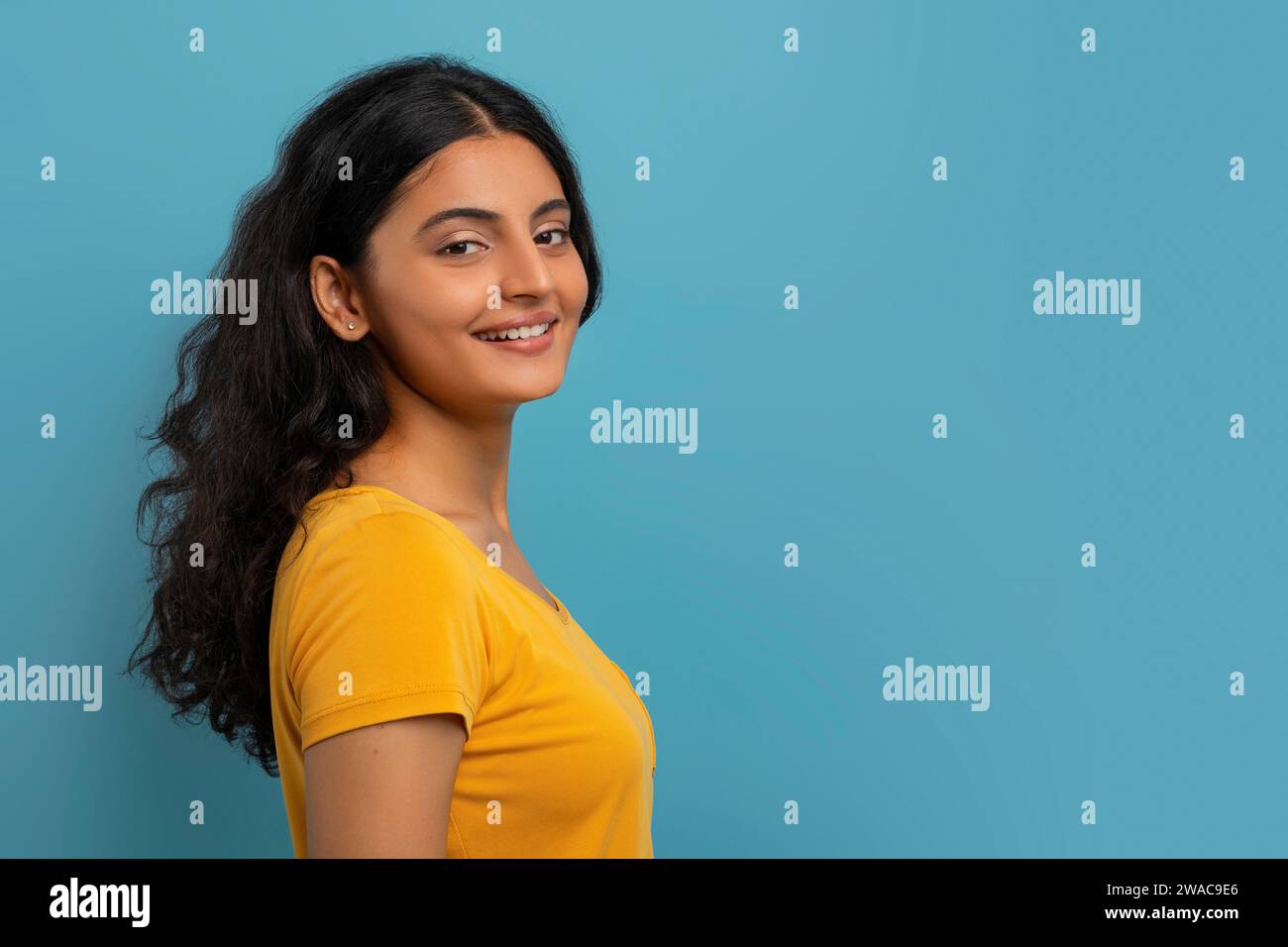 Profile portrait of attractive young indian woman posing on blue Stock ...
