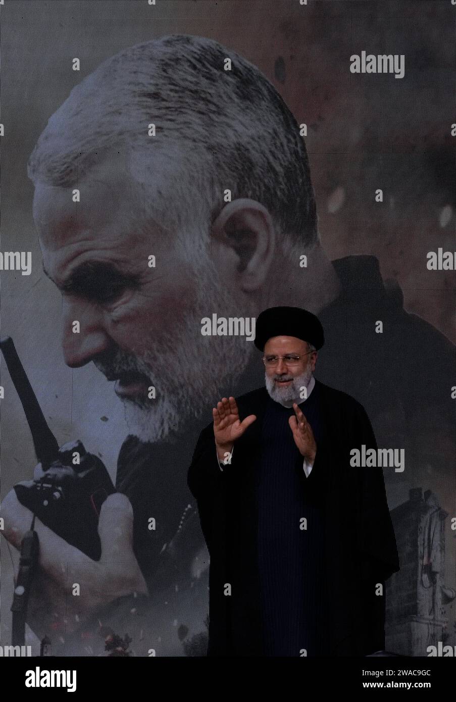 Iranian President Ebrahim Raisi waves to the crowd during a ...