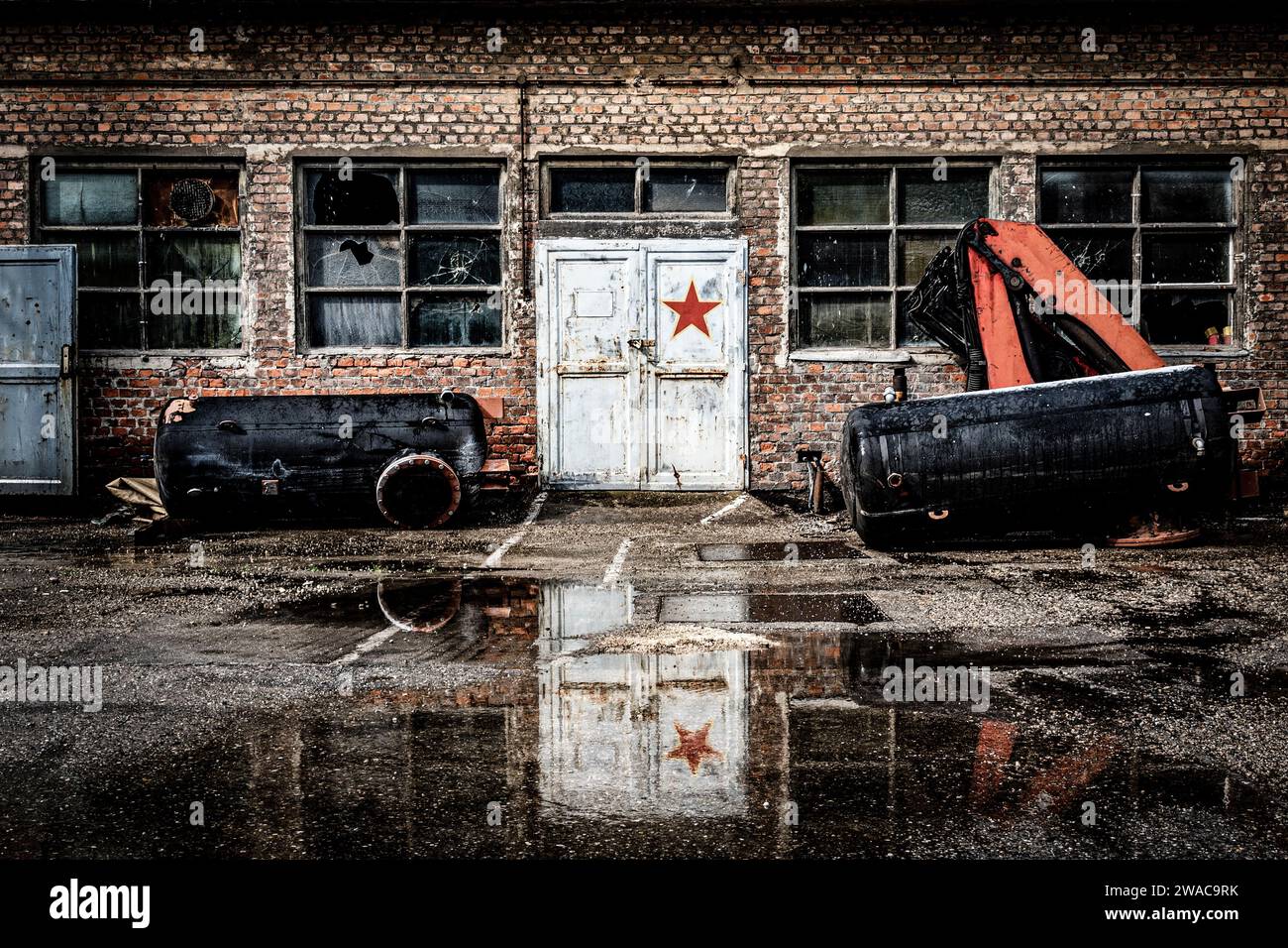 Old dilapidated communist factory with brick walls and broken windows ...