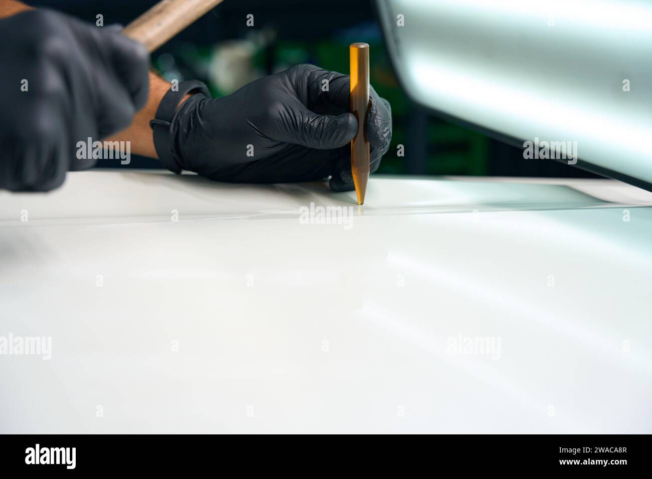 Process of using special gadget to level out body dents Stock Photo - Alamy