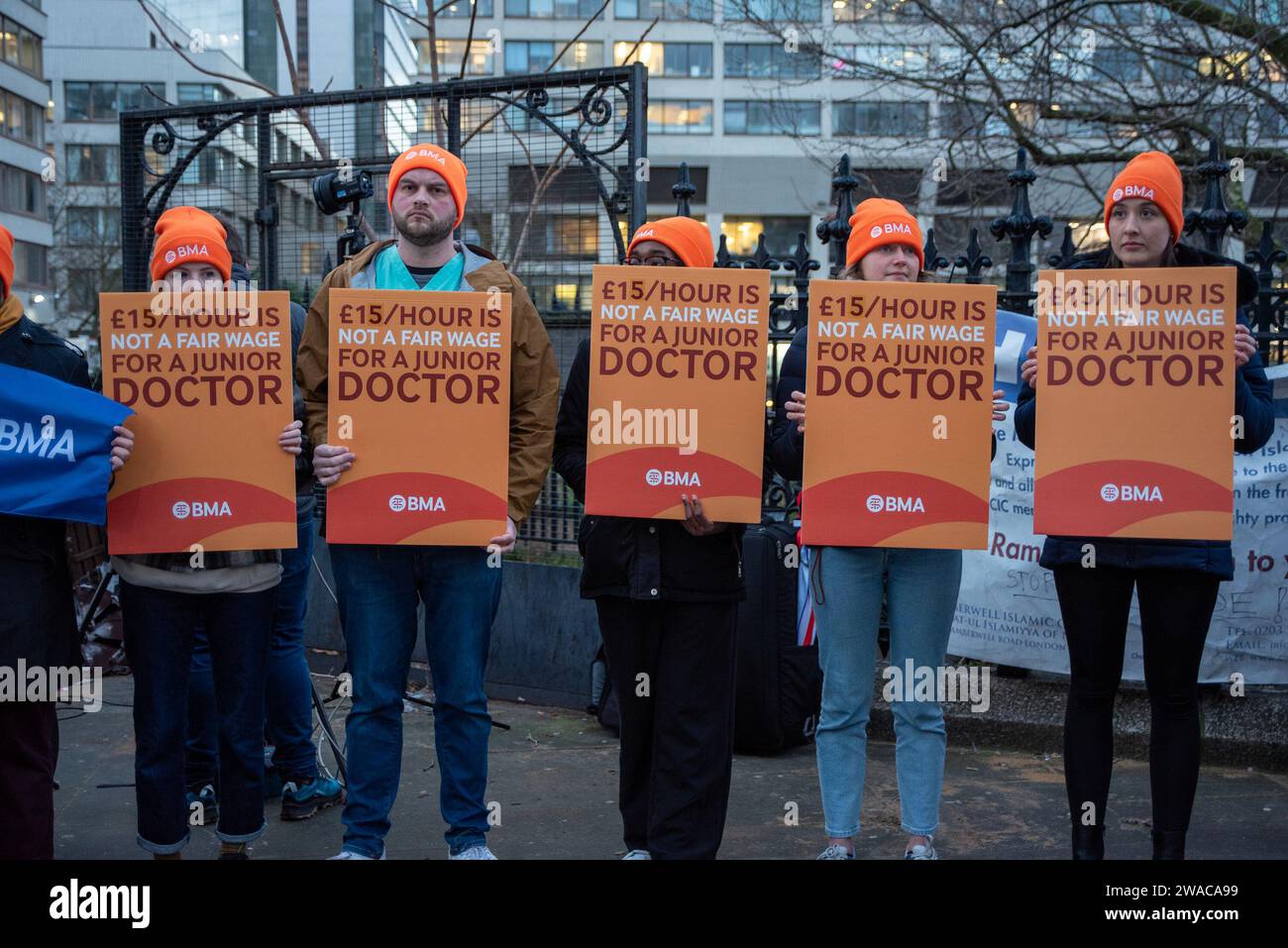 London, UK. 03rd Jan, 2024. Protesters hold placards expressing their ...