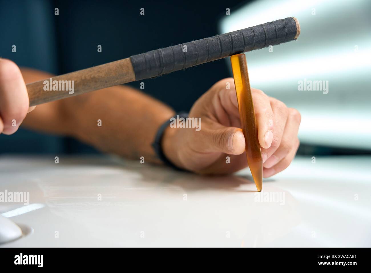 Using a special gadget to level out body dents Stock Photo - Alamy