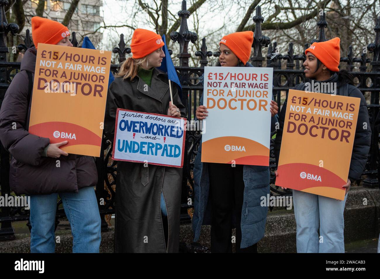 London, UK. 03rd Jan, 2024. Protesters hold placards expressing their ...