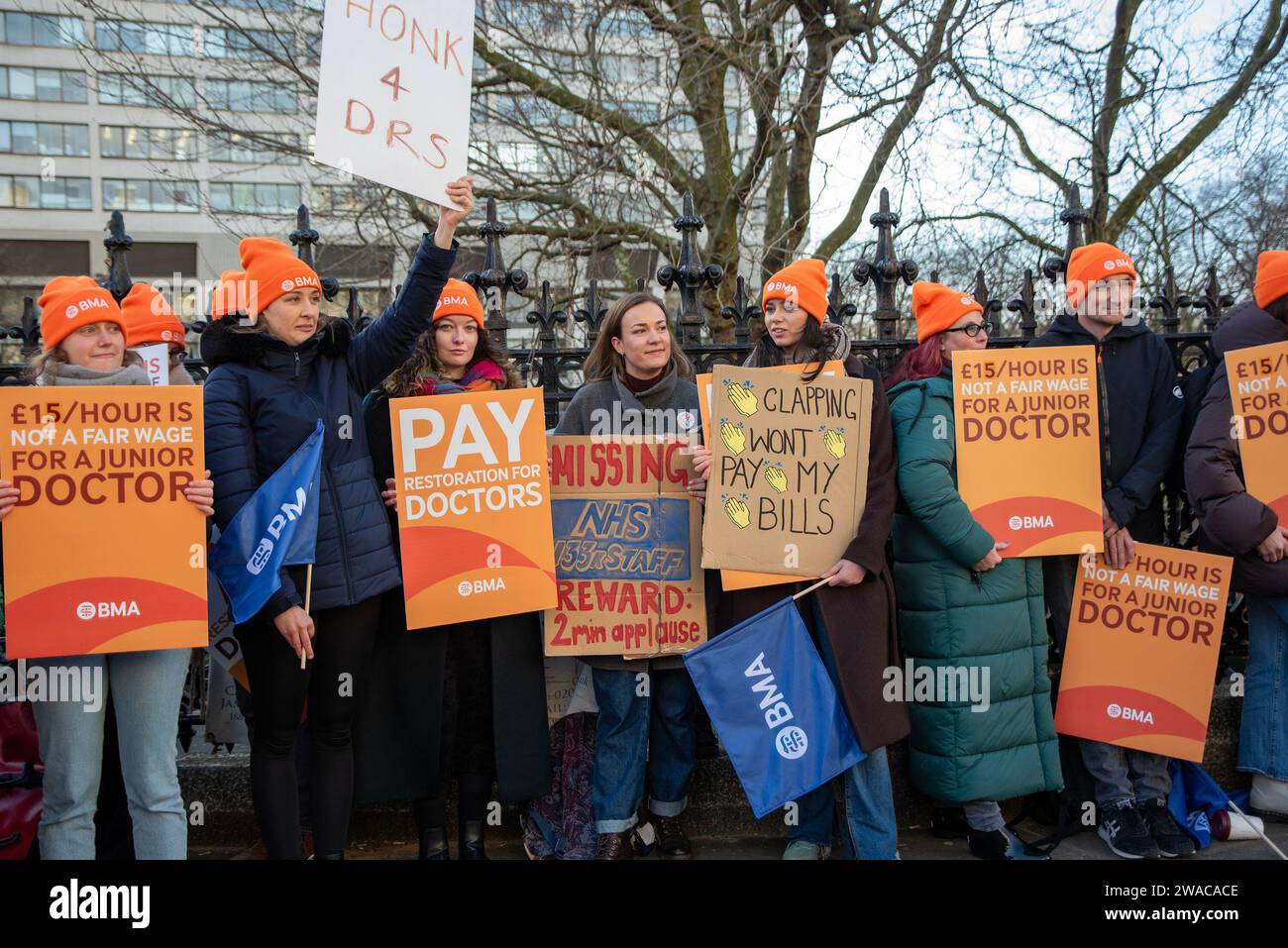 London, UK. 03rd Jan, 2024. Protesters hold placards expressing their ...