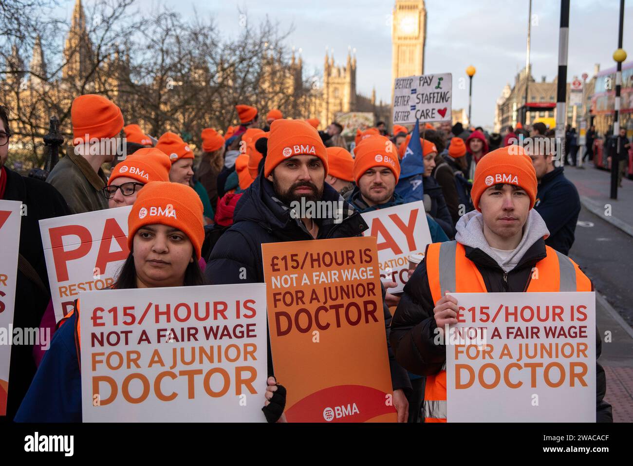 London, UK. 03rd Jan, 2024. Protesters hold placards expressing their ...