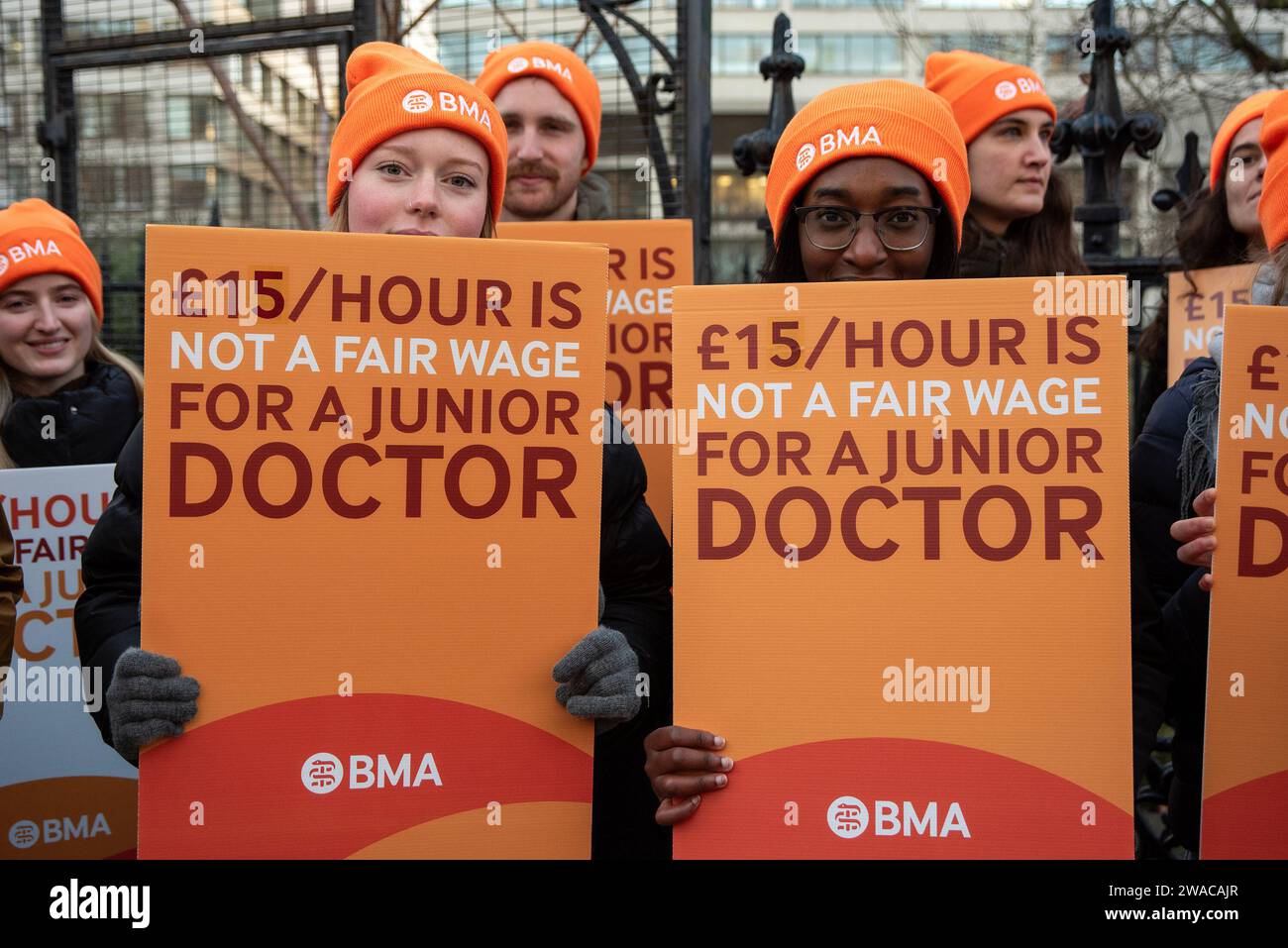 London, UK. 03rd Jan, 2024. Protesters hold placards expressing their ...