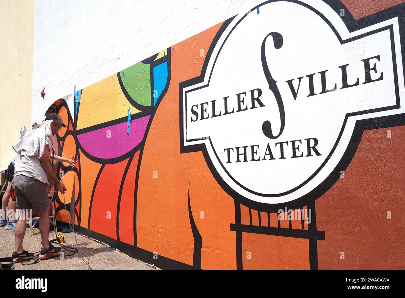 The painters' are painting the sign on the wall Stock Photo - Alamy