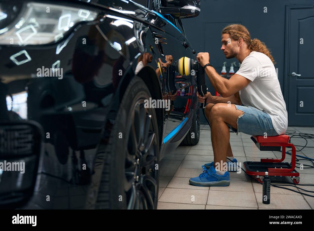 Detailing a modern car in a car repair shop Stock Photo - Alamy