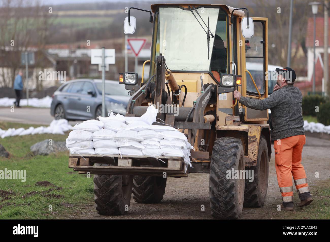 Kelbra, Germany. 03rd Jan, 2024. A wheel loader transports sandbags to ...