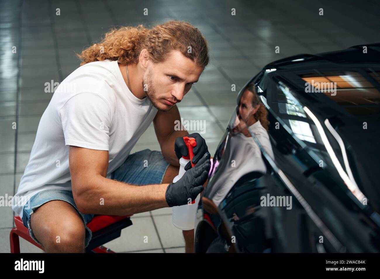 Male master is detailing a black car Stock Photo - Alamy