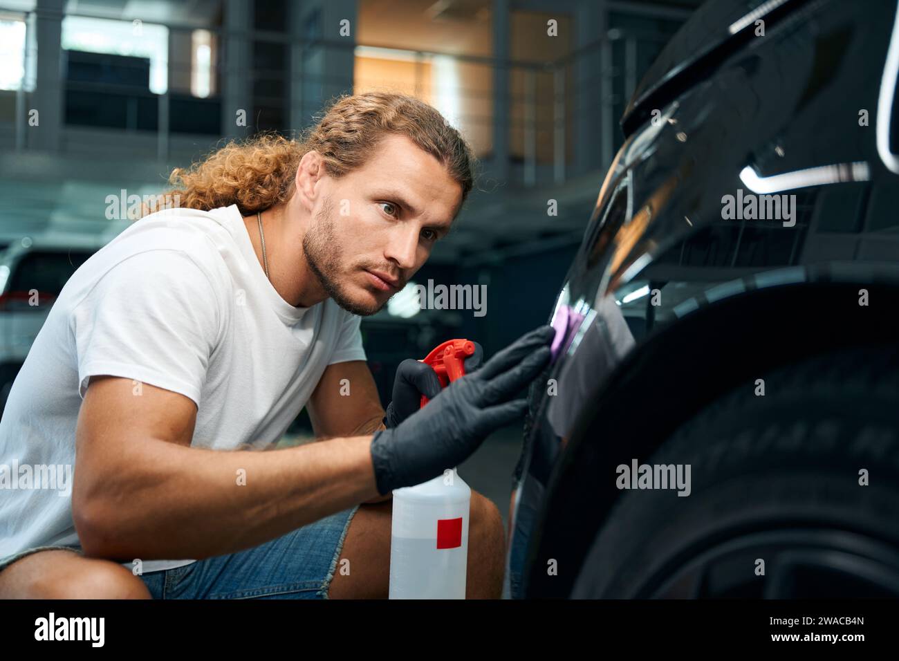 Young man provides a car detailing service Stock Photo - Alamy