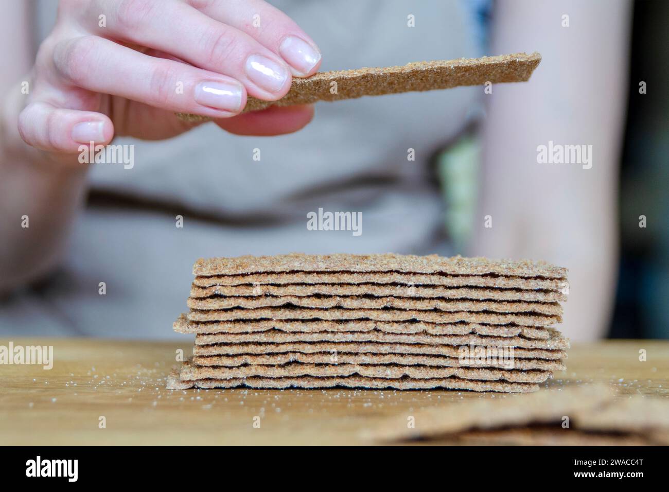 A woman's hand puts bread close-up. Sorting a small snack in the form ...