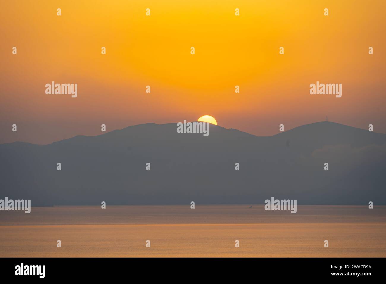 Dawn breaking behind the mountains of Mainland Greece from the Island ...