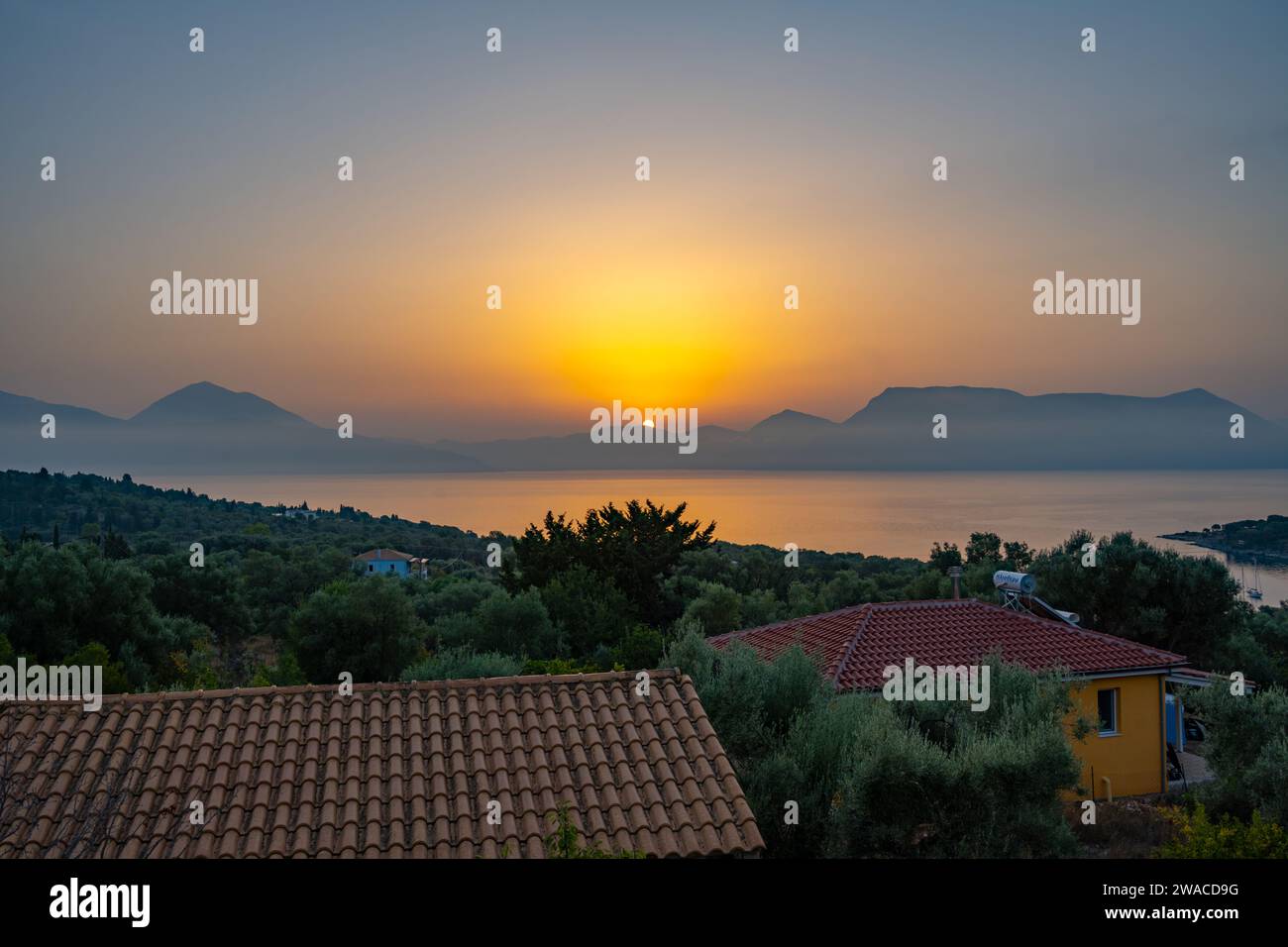 Dawn breaking behind the mountains of Mainland Greece from the Island ...