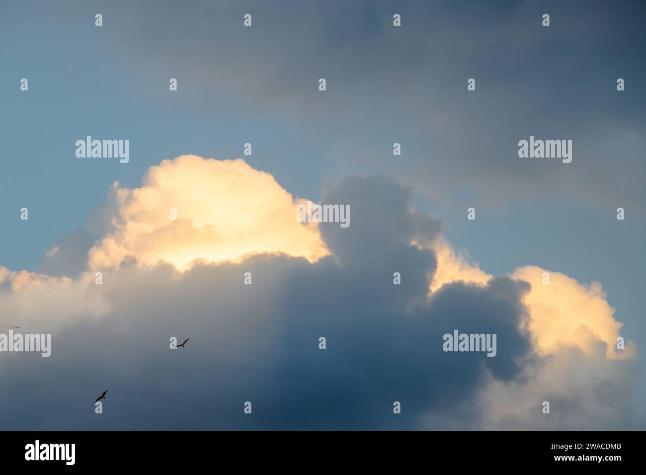 Dramatic cloudy sky with dense, dark clouds that contrast with the ...