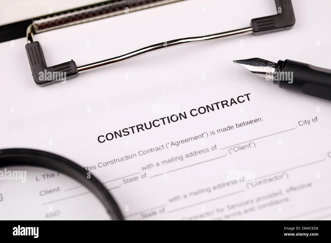 Construction contract form on A4 tablet lies on office table with pen ...