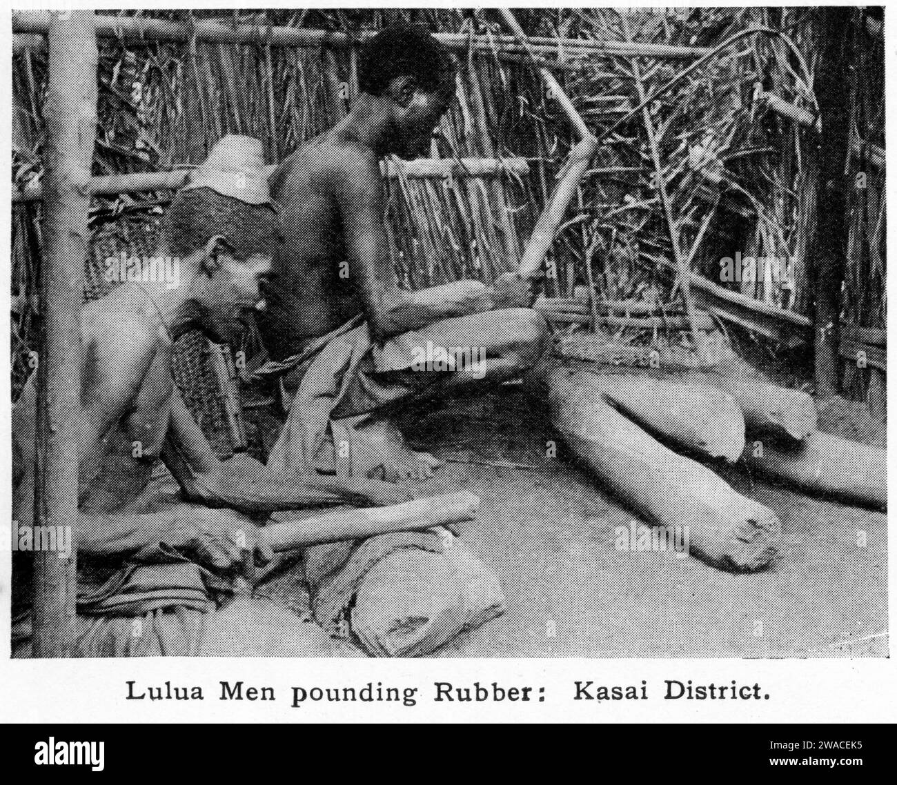 halftone of Lulua men pounding rubber, circa 1913. The Lulua people are ...
