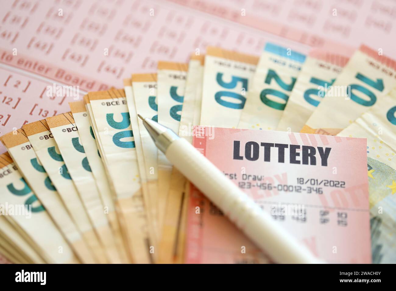 Lottery ticket and gambling receipt on table with pen and European ...