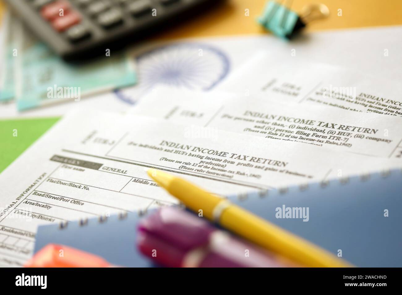 Indian income tax return blank form with pen and indian rupees bills on ...