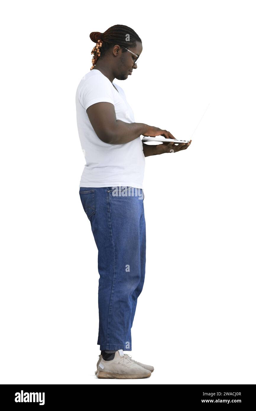 Full-length man in a white T-shirt typing on a laptop on a White ...