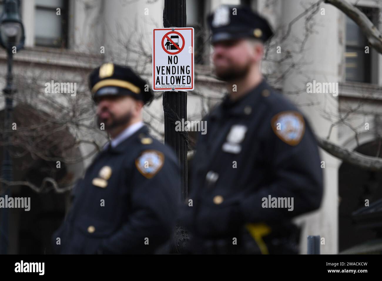 New York, USA. 03rd Jan, 2024. Two NYPD officers stand at the Manhattan ...