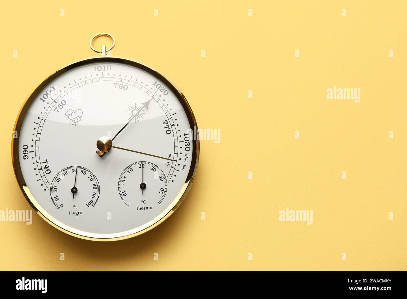 Aneroid barometer on yellow background Stock Photo - Alamy