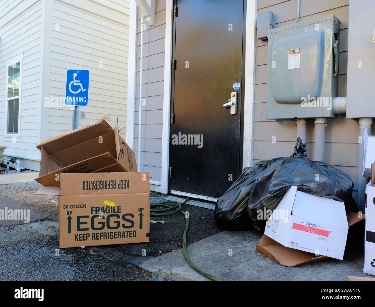 An empty box of thirty dozen eggs behind a restaurant backdoor alley ...