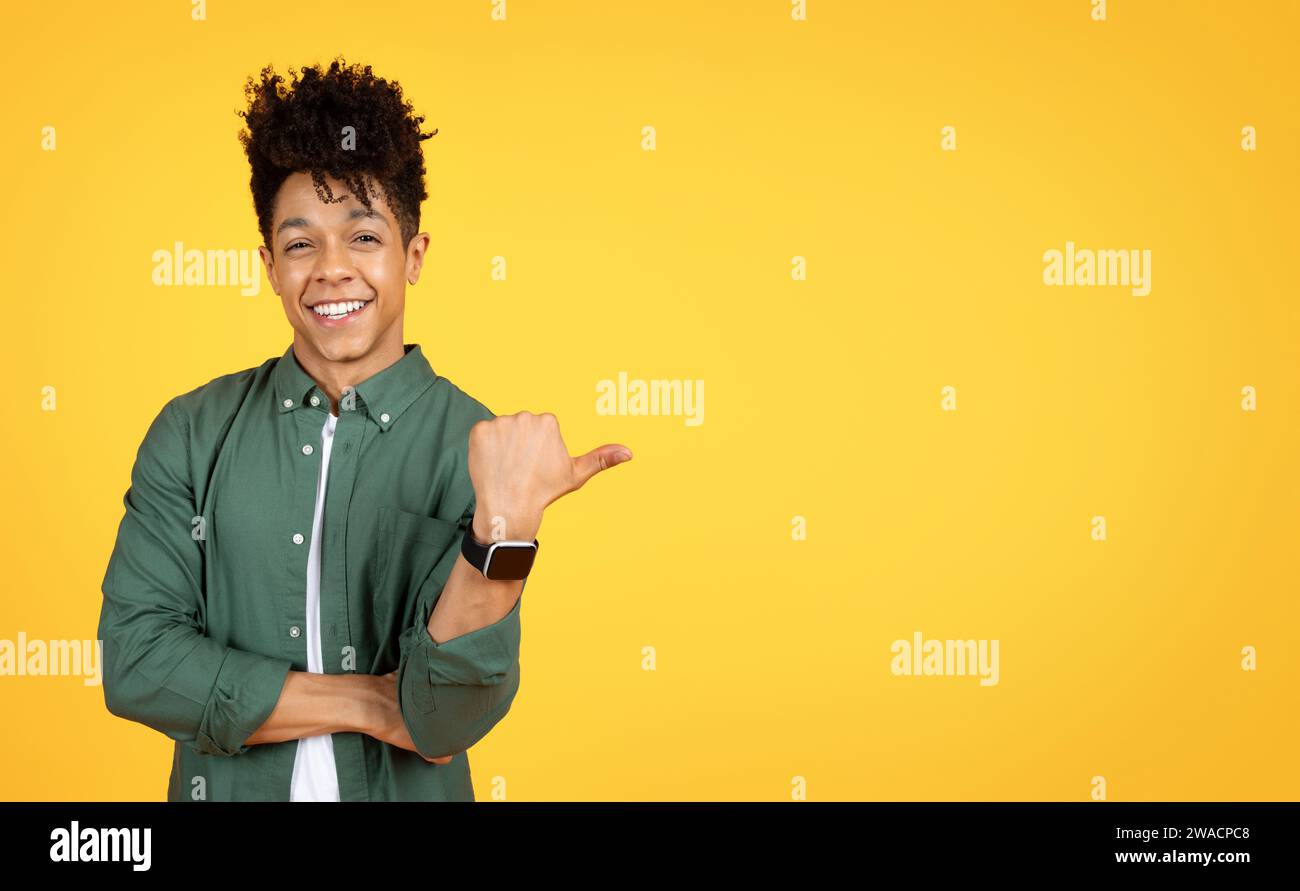 Cool handsome african american guy pointing at copy space Stock Photo ...