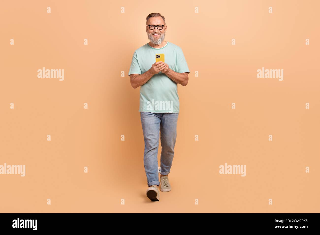 Full size portrait of positive cheerful aged person hold smart phone ...